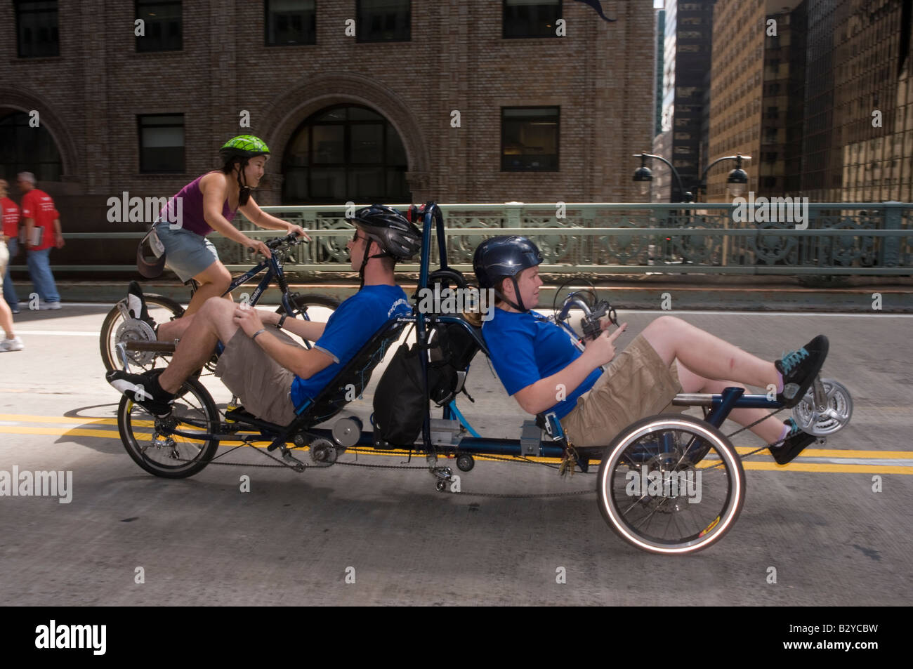 Two cyclists on a recumbent tandem bicycle during Summer Streets Stock ...