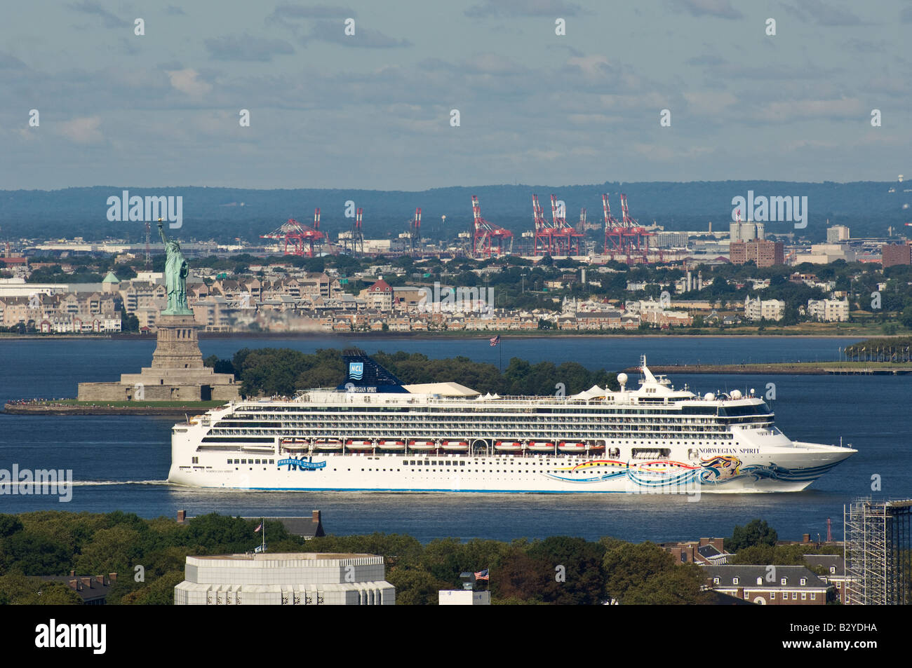 Cruise ship passing the Statue of Liberty entering New York harbour ...