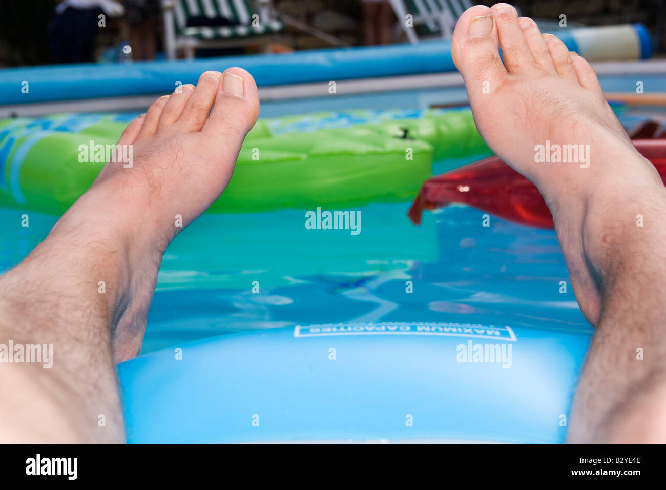 view of feet in inflatable boat with other inflatables in view Stock ...