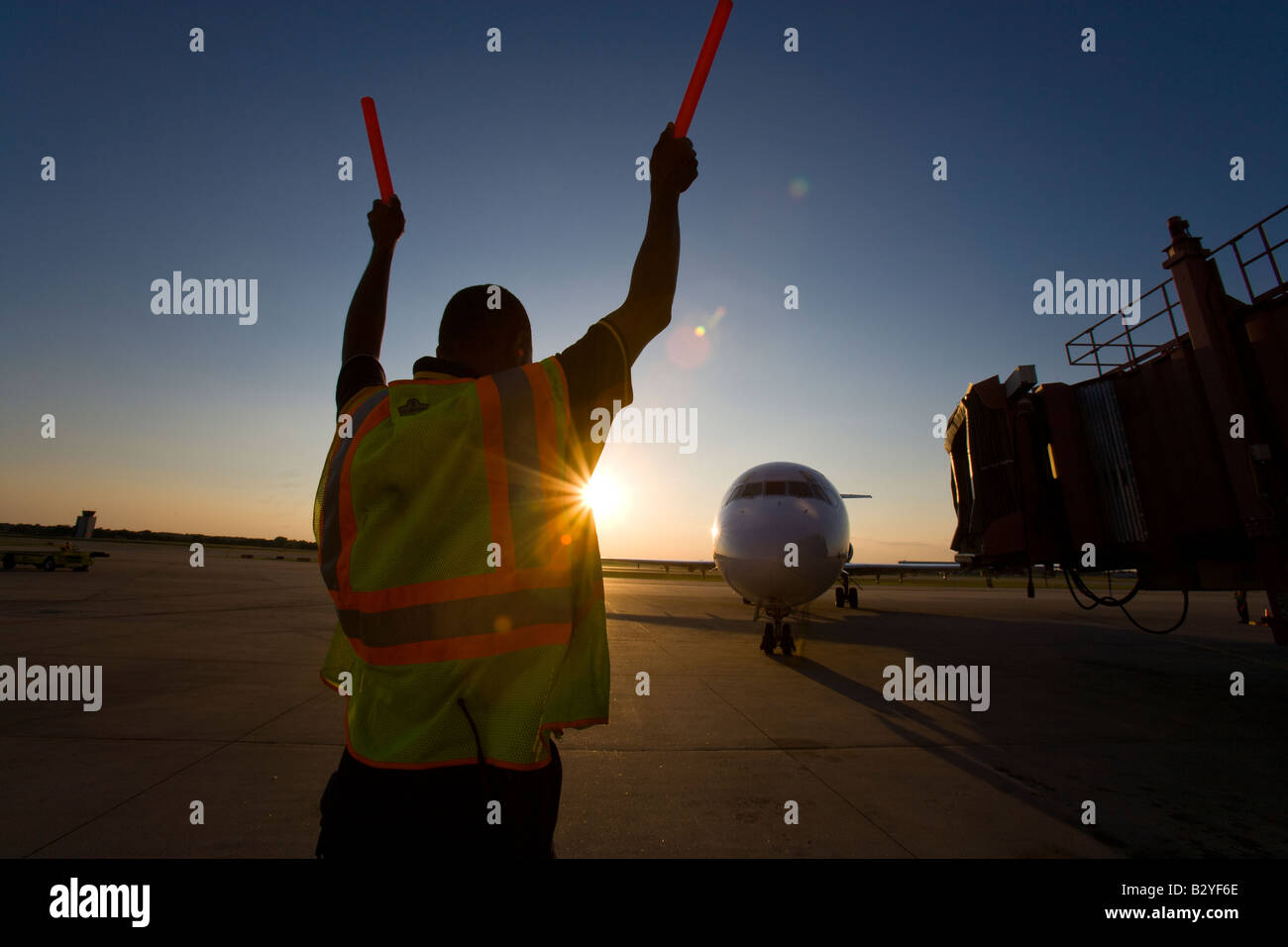 Airplane is guided by a airport worker at terminal at the Springfield ...