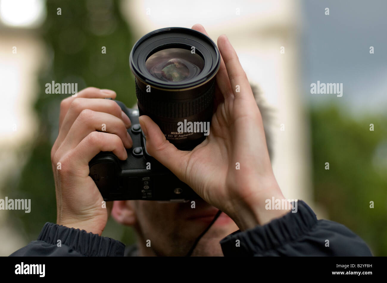 Young man taking a photograph Stock Photo - Alamy