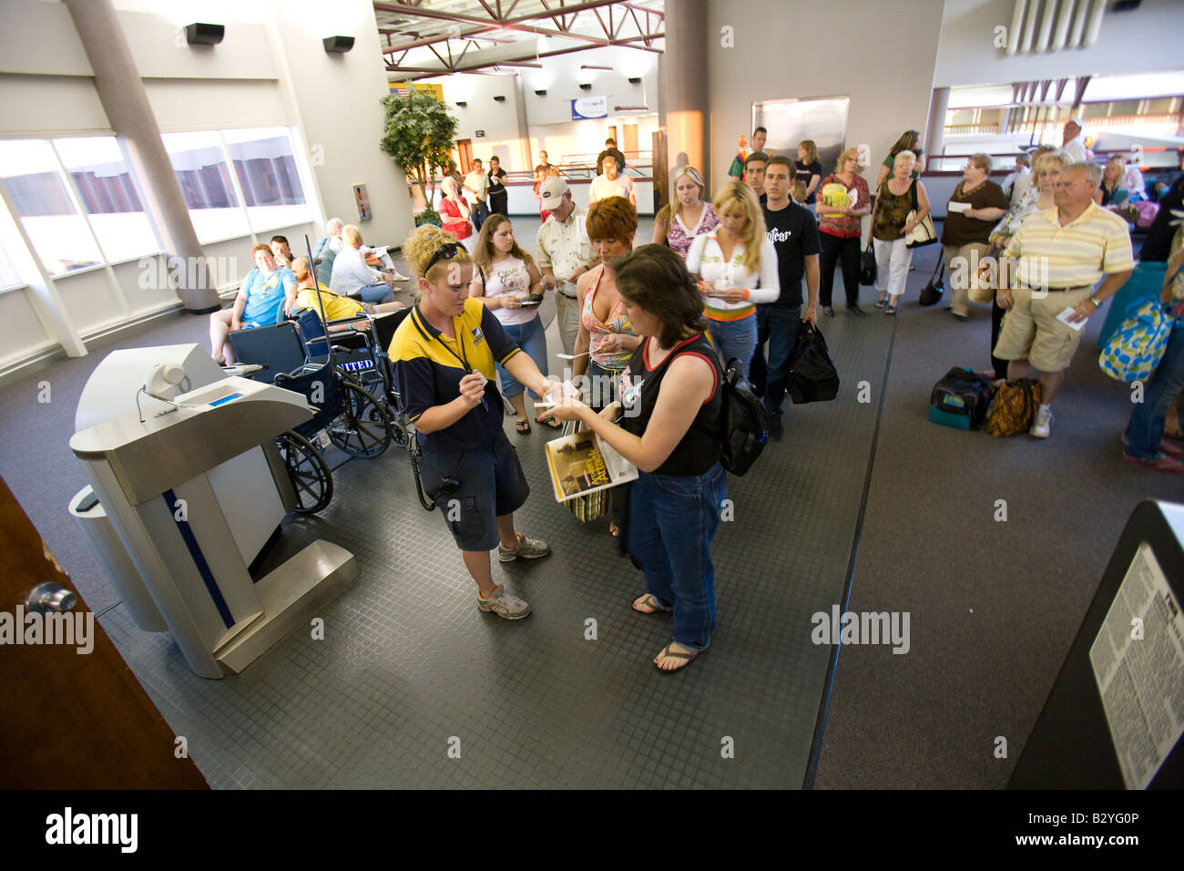 People wait in the lobby (waiting room) and prepare to board the ...