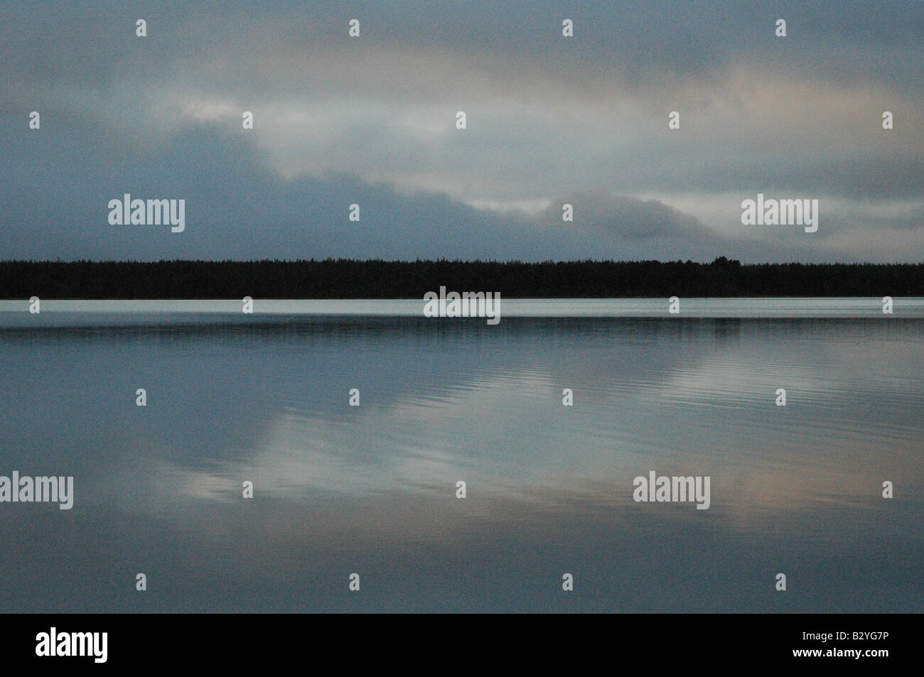reflective minimal land image with sky and loch Stock Photo - Alamy