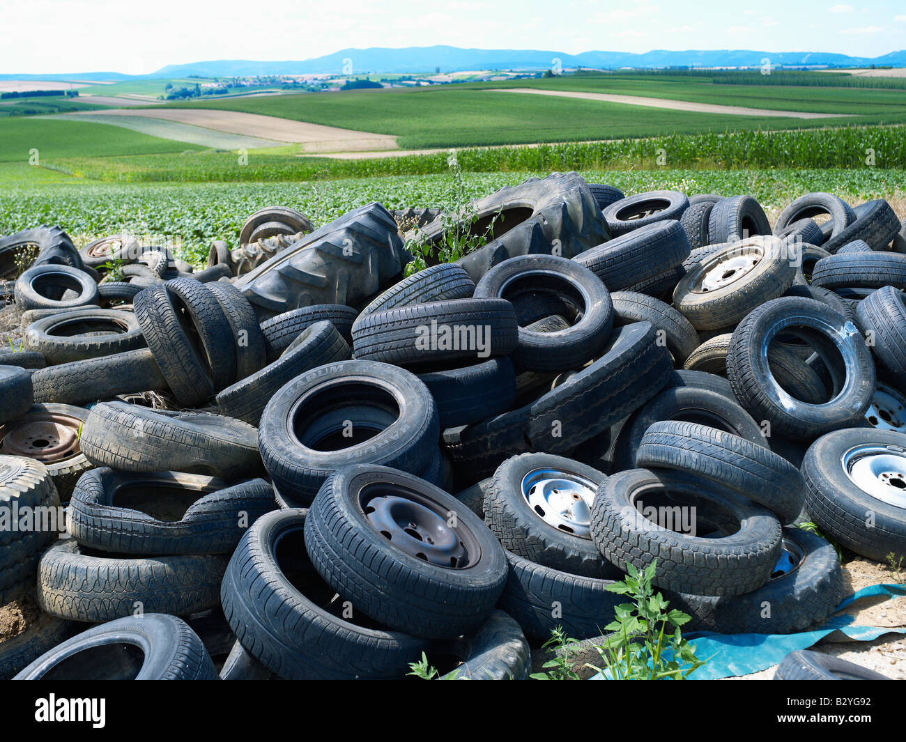 OLD CAR TIRES DUMPED ON FARMLAND ALSACE FRANCE Stock Photo - Alamy