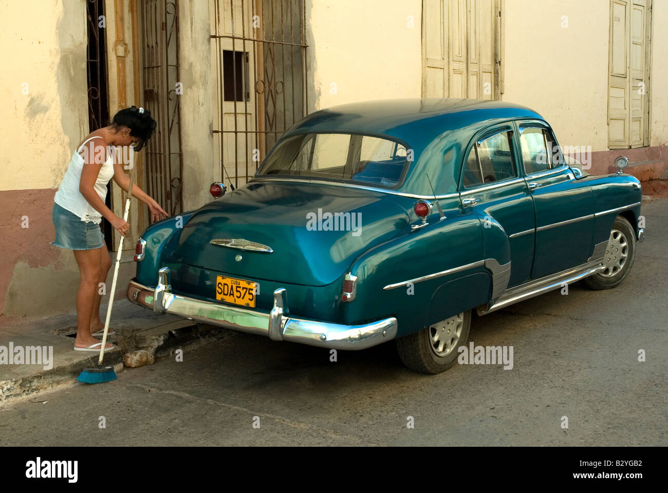 Woman sweeping street outside hi-res stock photography and images - Alamy