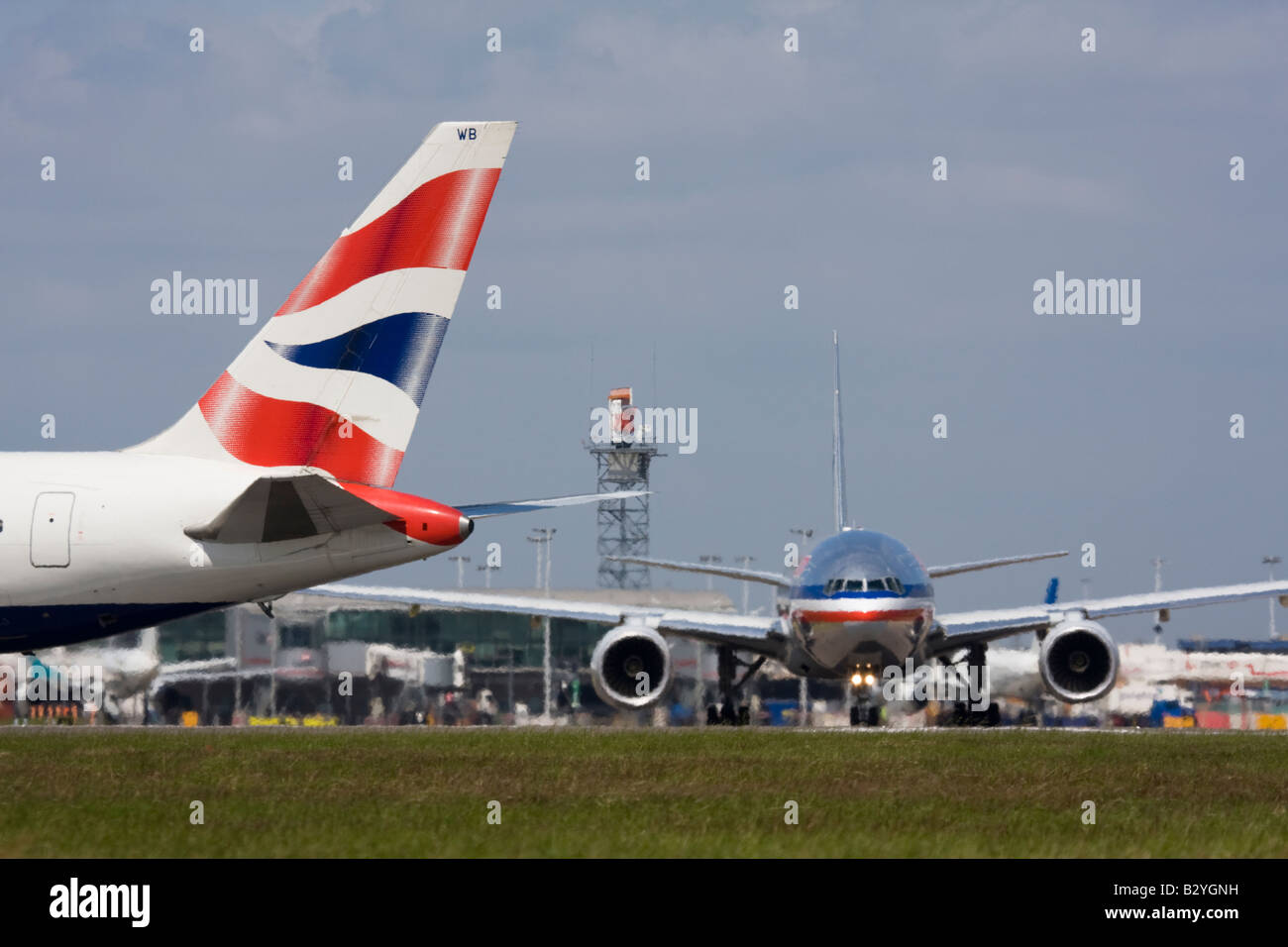 The tail of British Airways plane and American Airlines plane Boeing ...