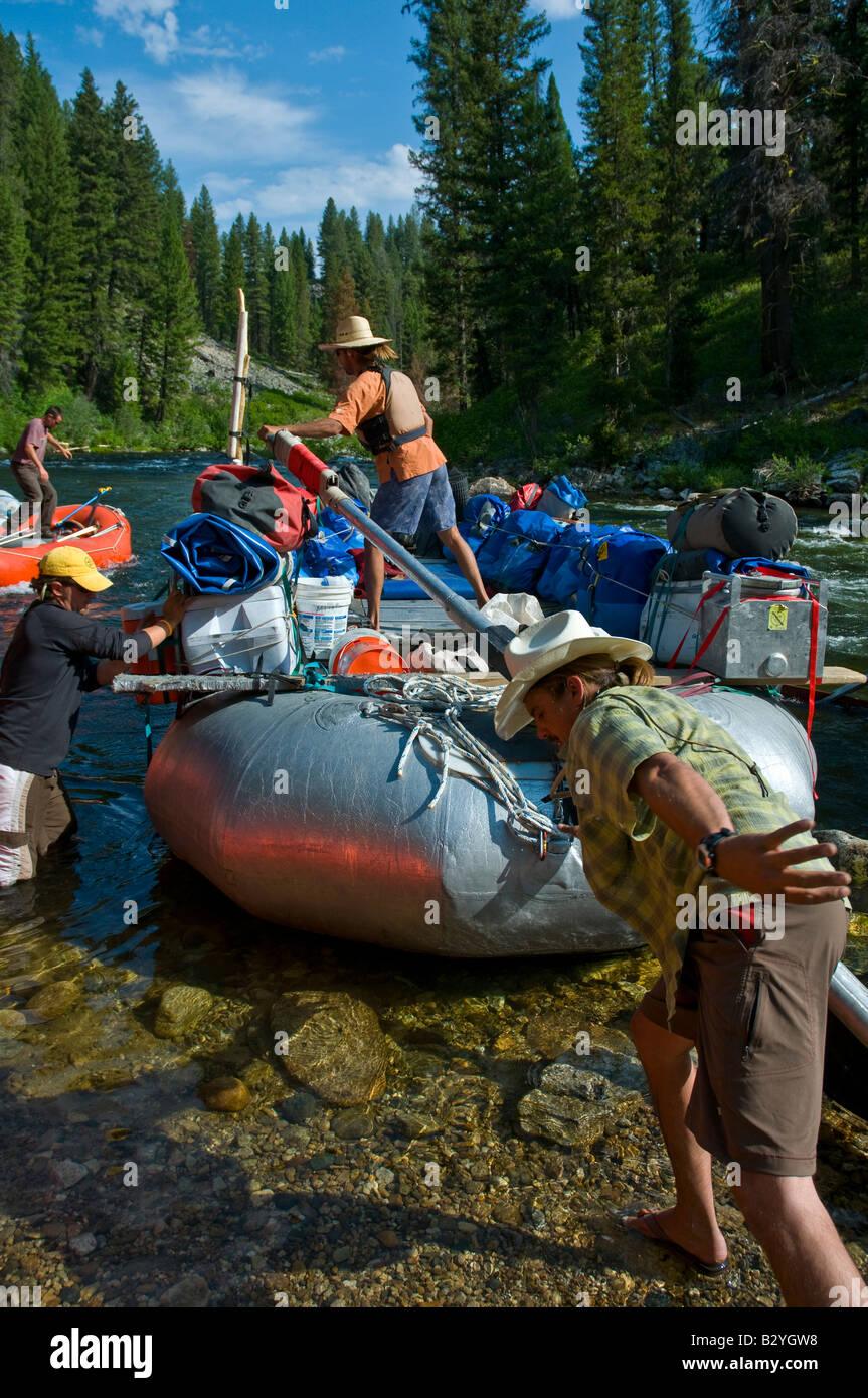 Idaho, Middle Fork of the Salmon River. Guides push out the sweep boat ...