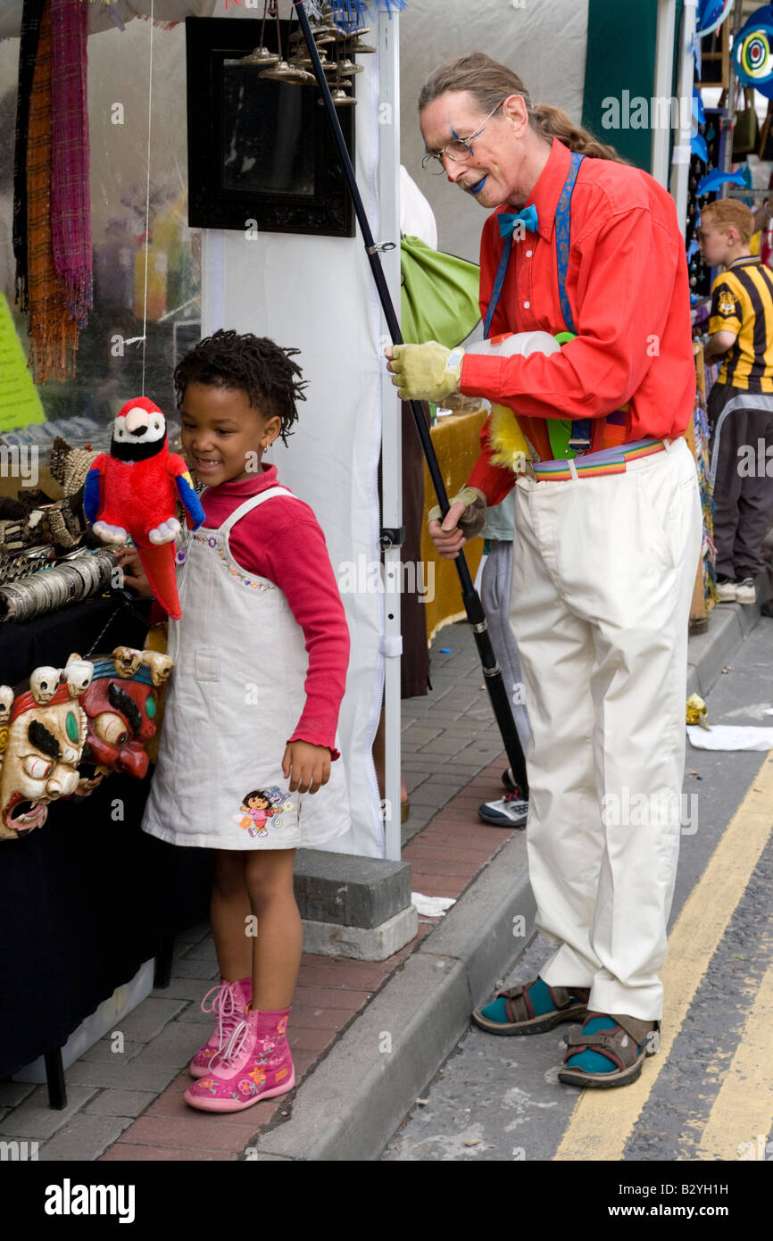 Clown amusing small child with puppet on a string Stock Photo - Alamy
