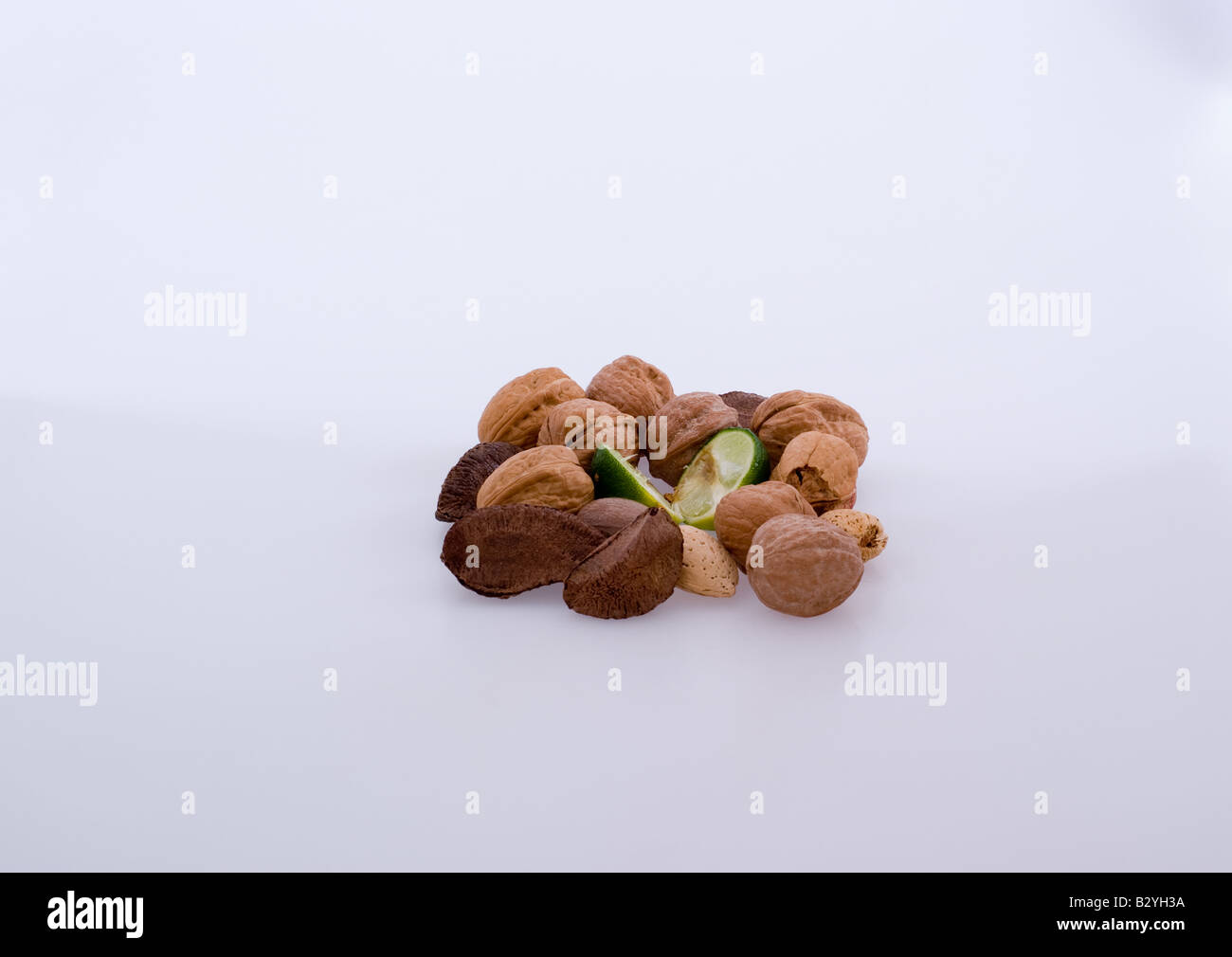 Various shelled nuts surrounding a key lime split open Stock Photo - Alamy