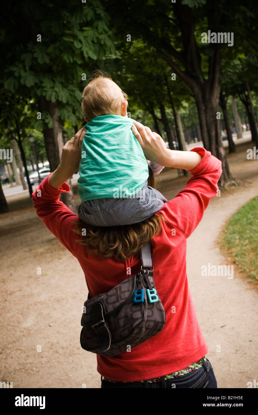 Child riding on his mother's shoulders Stock Photo - Alamy