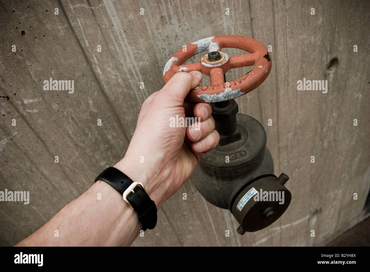 Man s hand turning the handle of a water main MODEL RELEASED Stock ...