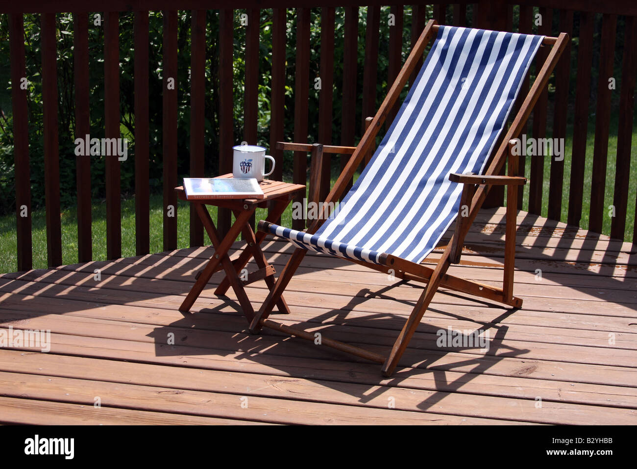 Relaxing and reading on the deck in the summer Stock Photo - Alamy