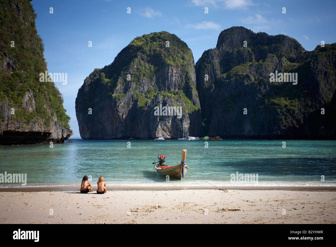 Two women sit in isolation on a remote Thailand island Stock Photo - Alamy