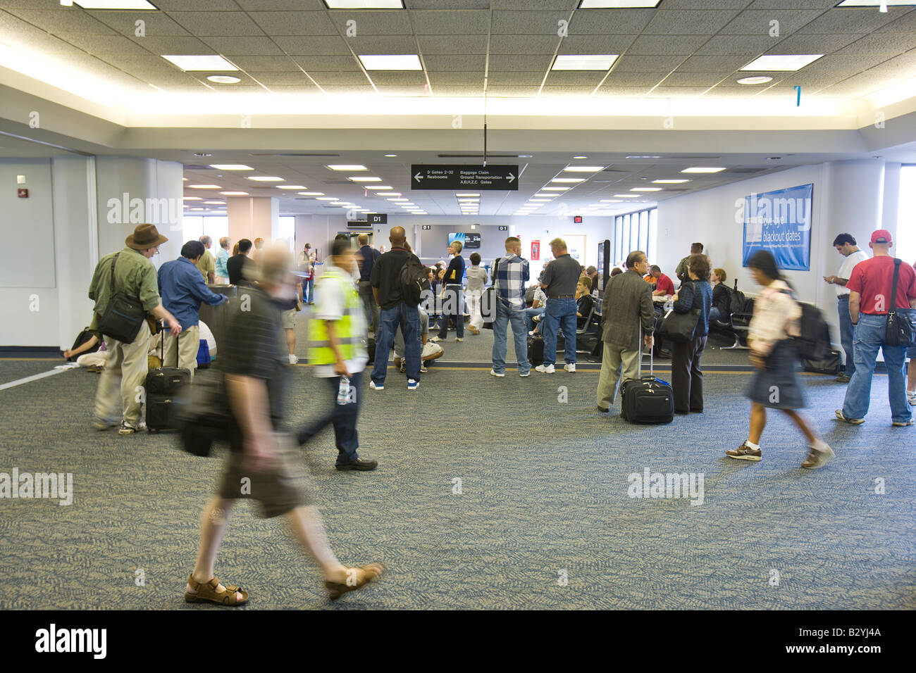 People wait in the lobby (waiting room) and prepare to board the ...