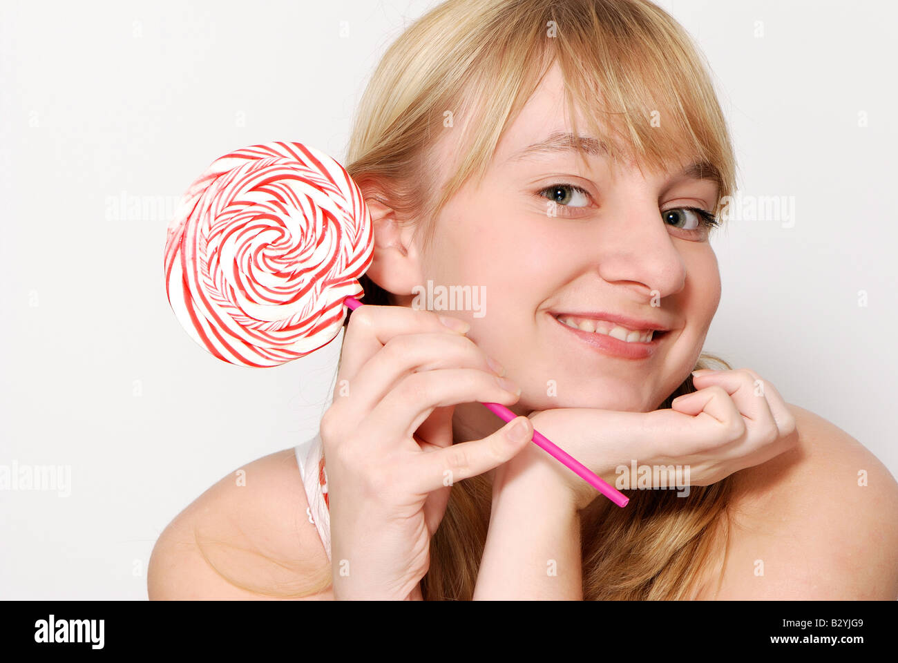 The girl with a sugar candy on a stick is emotional Stock Photo - Alamy
