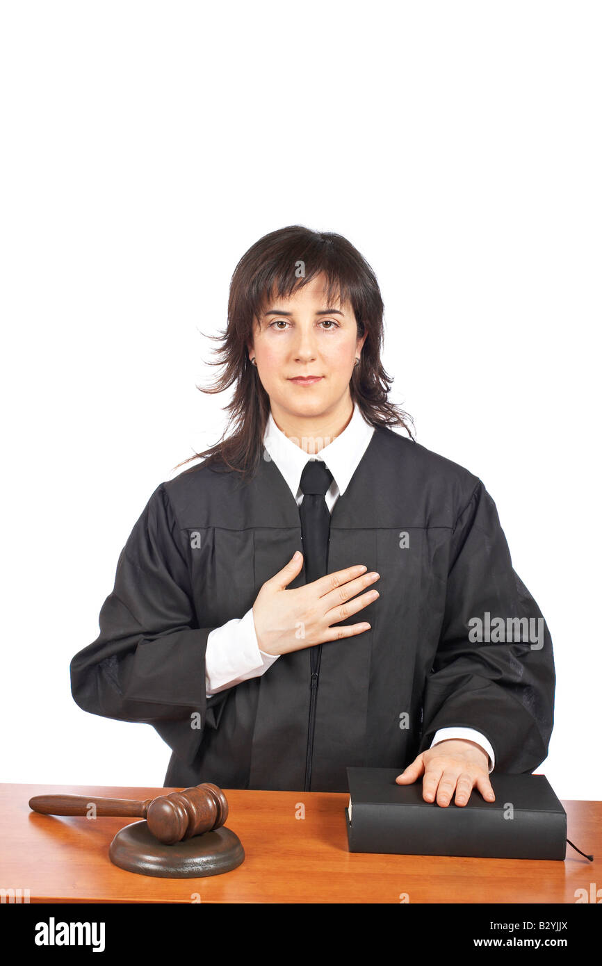 A female judge taking oath in a courtroom isolated on white background ...