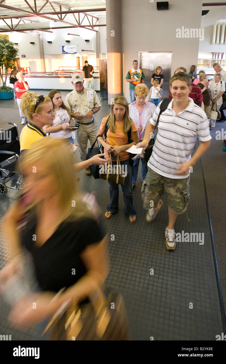 People wait in the lobby (waiting room) and prepare to board the ...