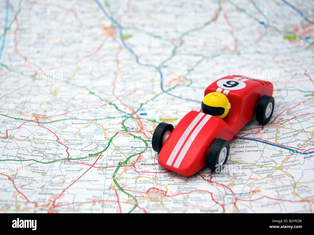 Red toy racing car on a road map Stock Photo - Alamy