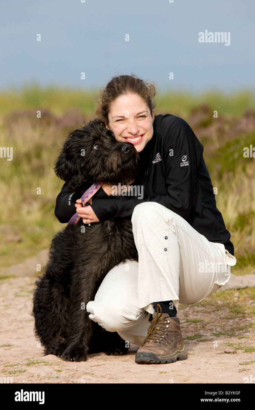 Smiling happy woman embracing Labradoodle pet dog Stock Photo - Alamy