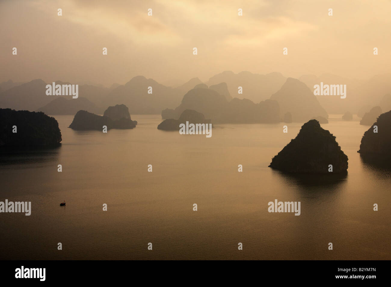 An elevated view of a small boat navigating through tropical islands ...
