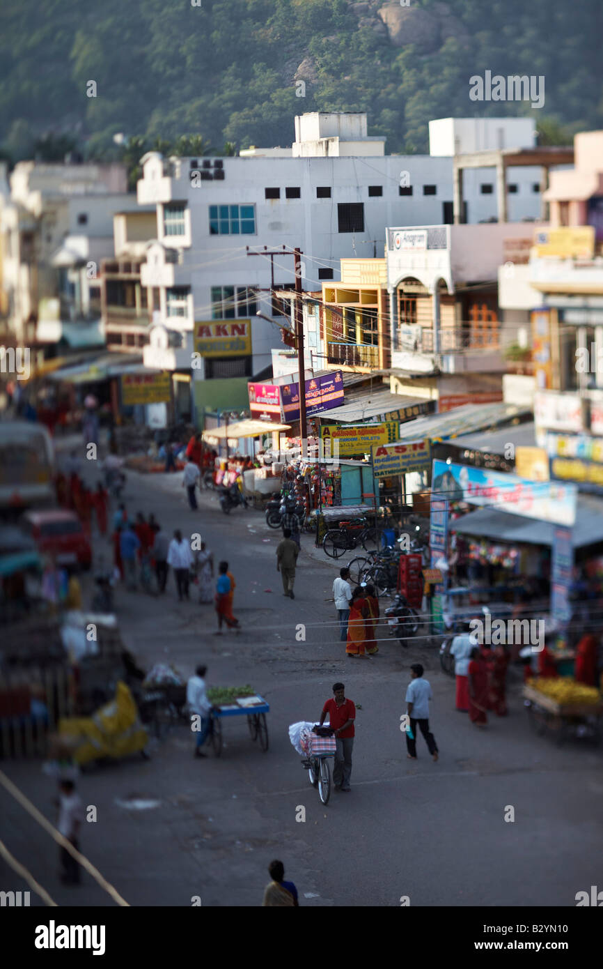 A view down the street of a small Indian town with a mountain on the ...