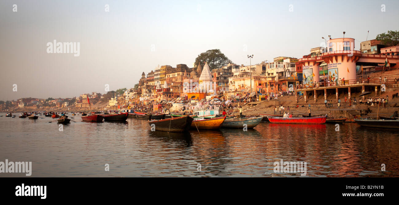 A panoramic image of the Ganges River with boats and temples in ...