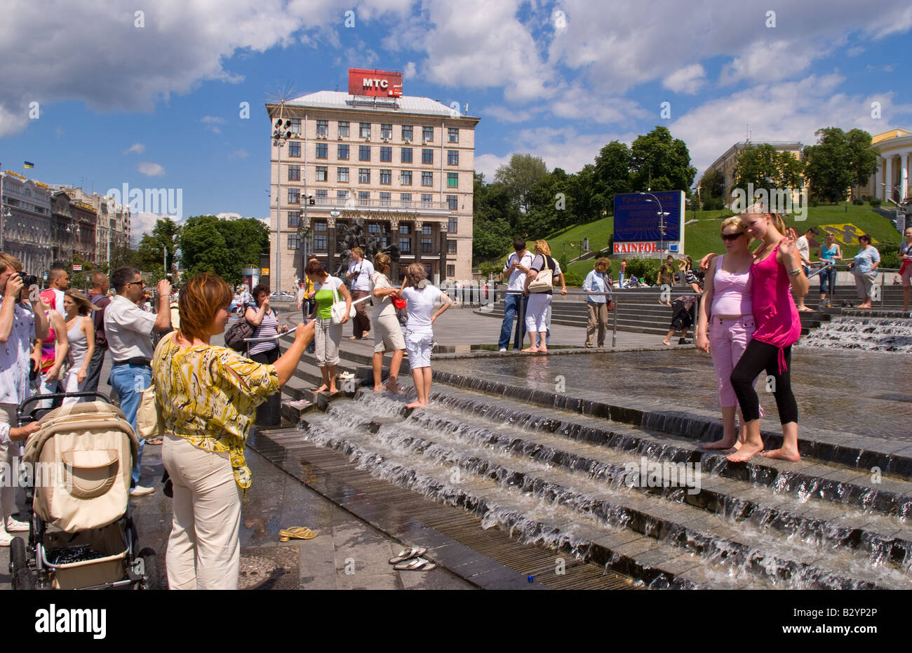 People playing in street fountain and taking photo near Independence ...