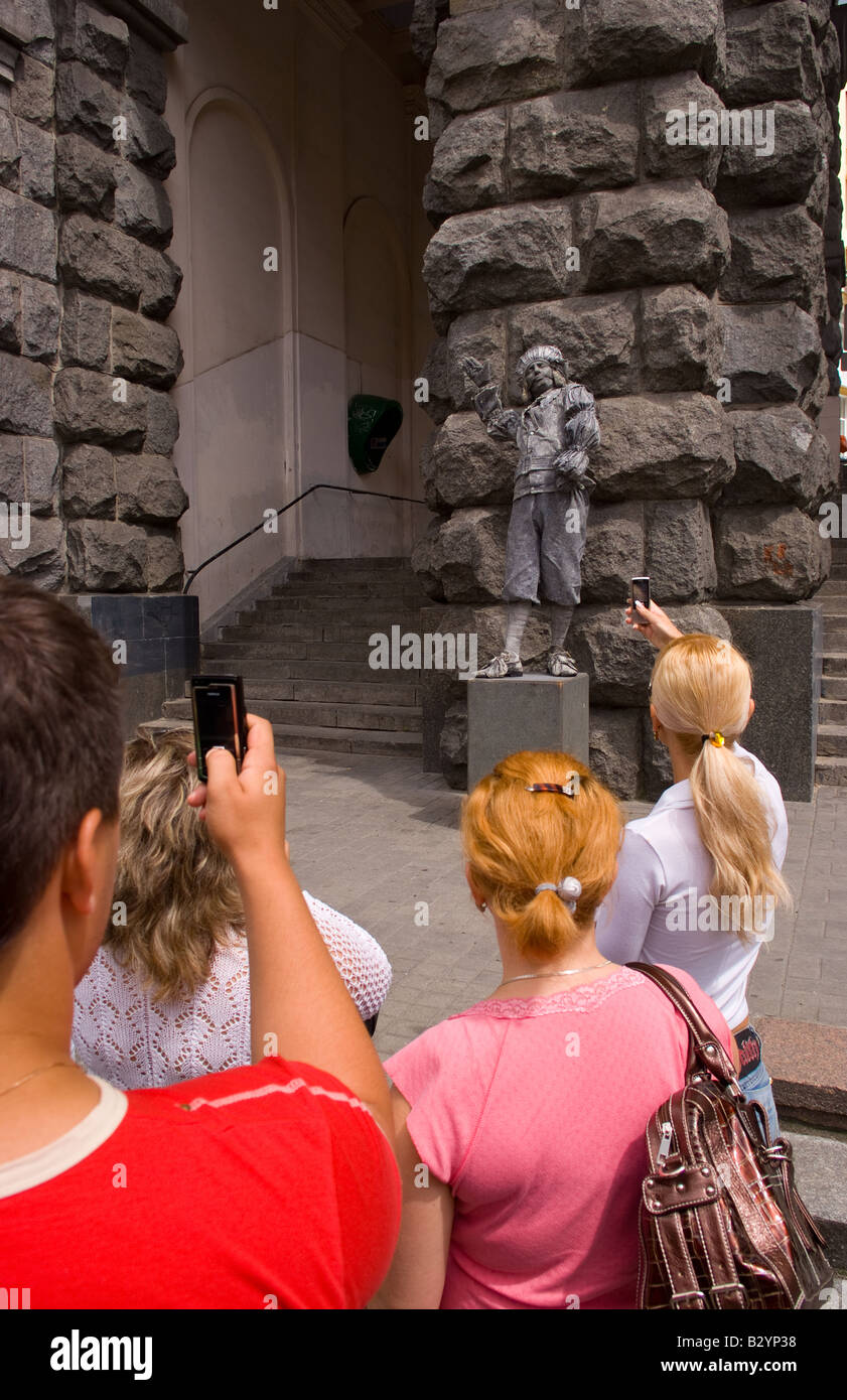 Crowd taking pictures while watching mime in city center festival in ...