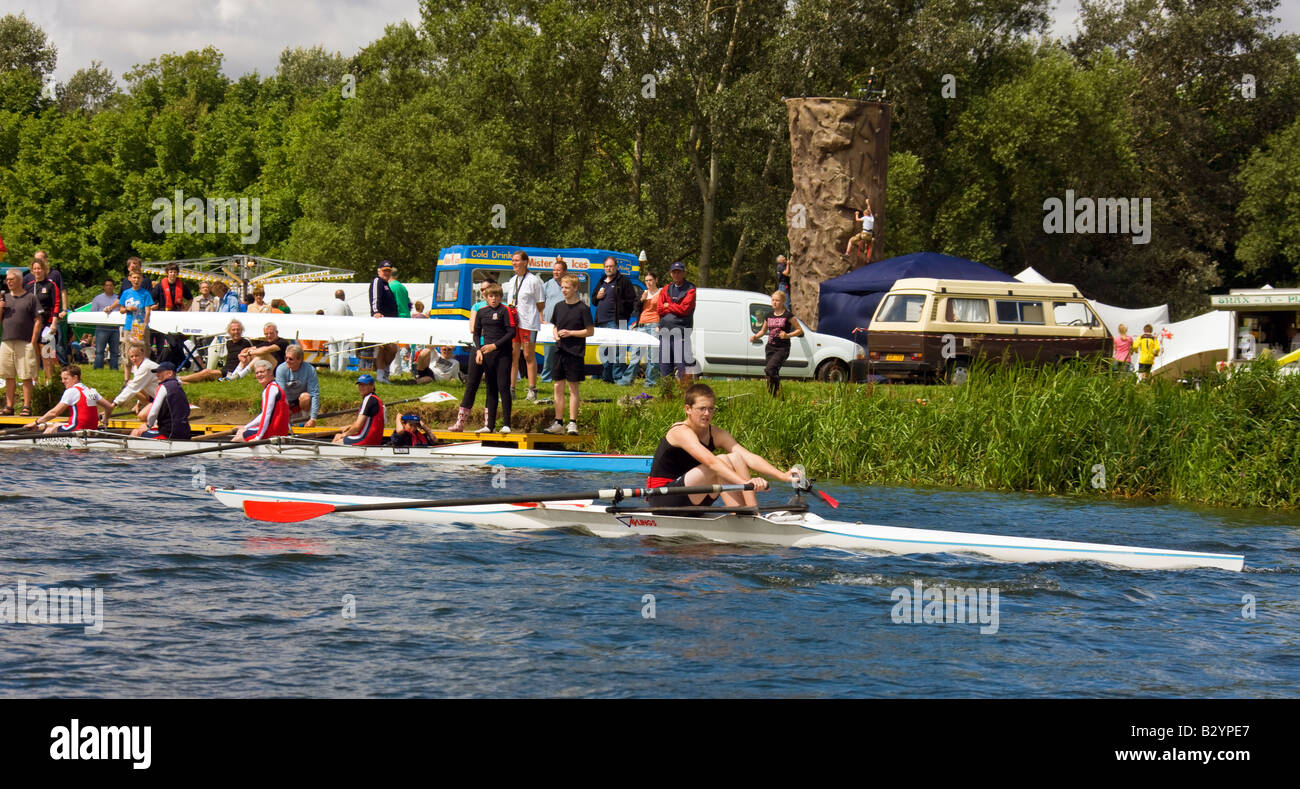 Young boy in a scull heading to the race finish past the on-lookers on ...