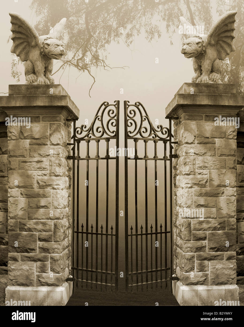 Gate With Winged Dog Statues Stock Photo - Alamy