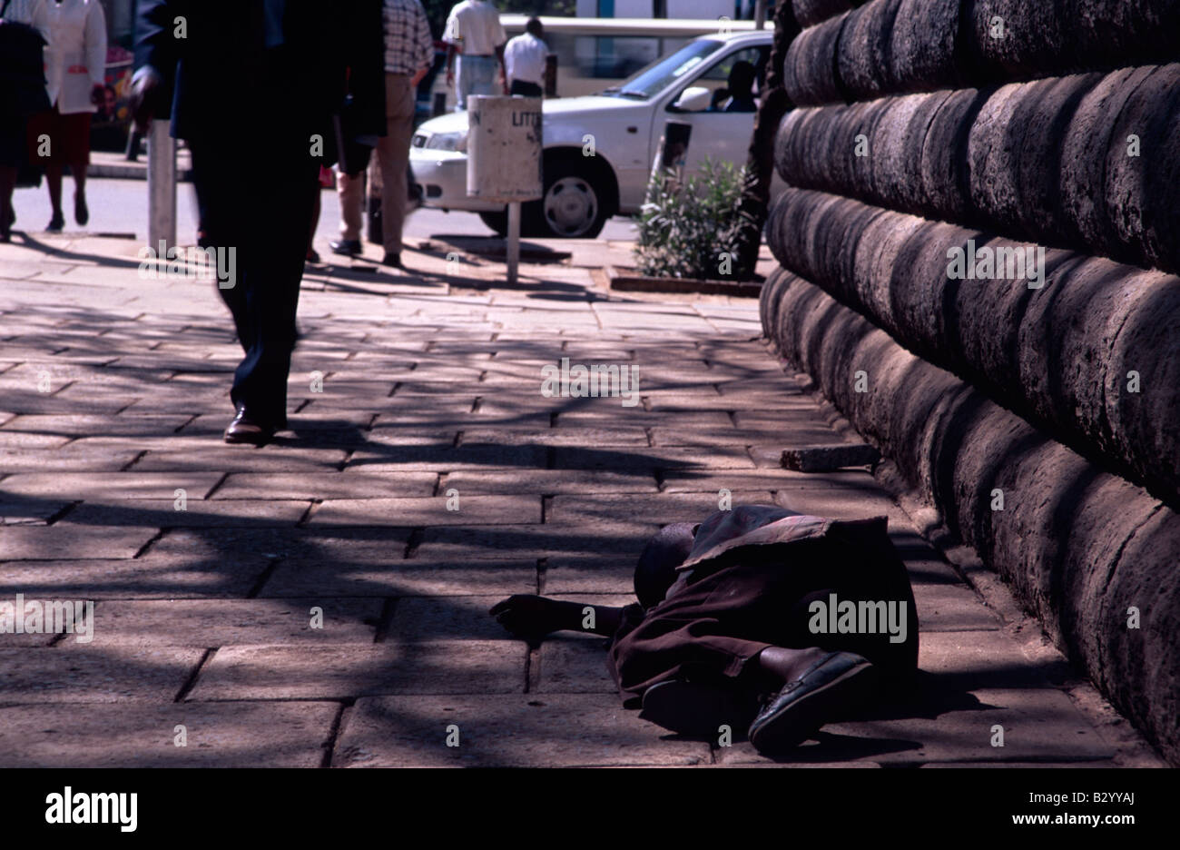 Homeless child sleeping on sidewalk, Nairobi, Kenya Stock Photo - Alamy