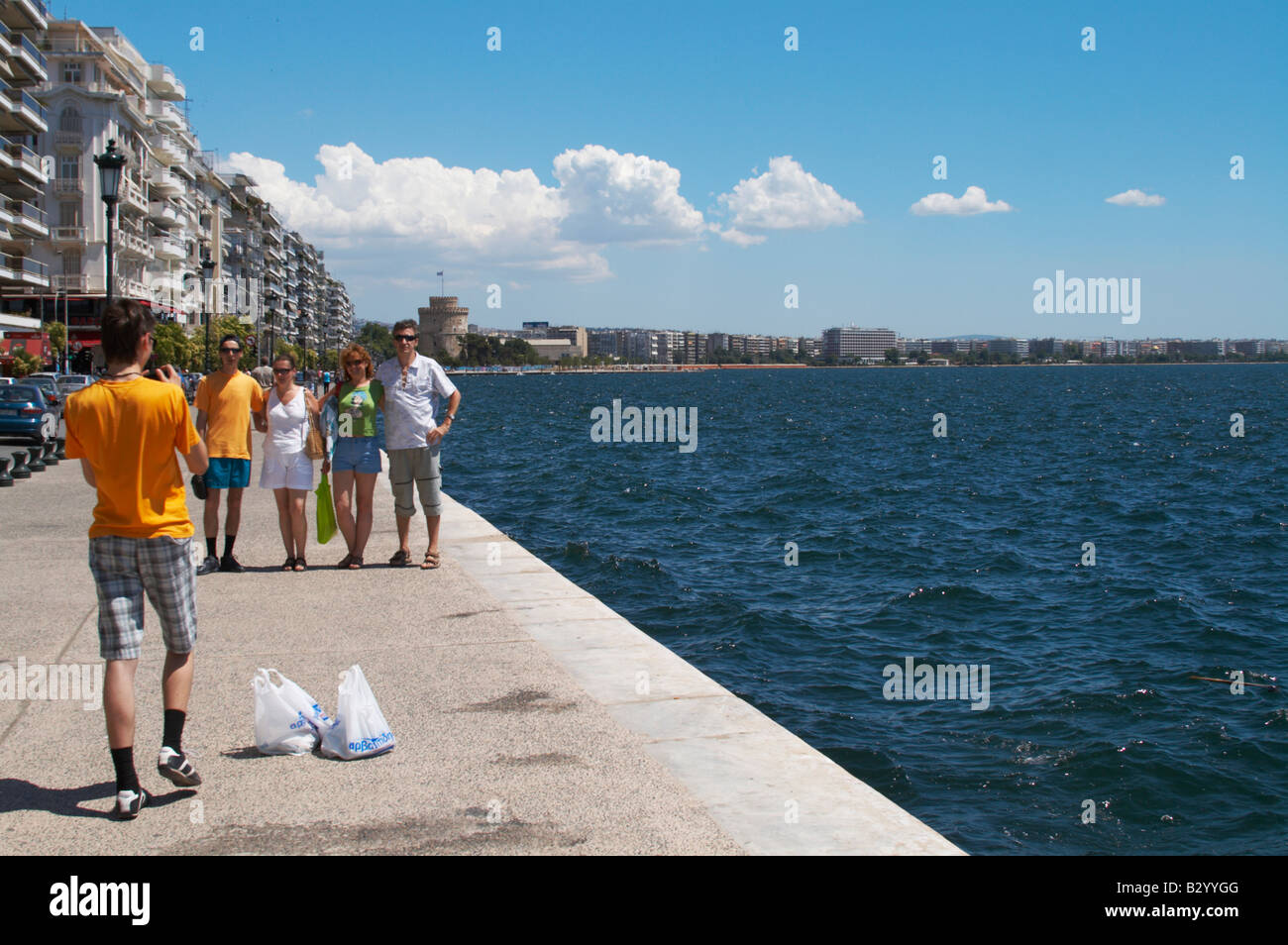 The waterfront. Walking along the seafront. Group of tourists taking ...