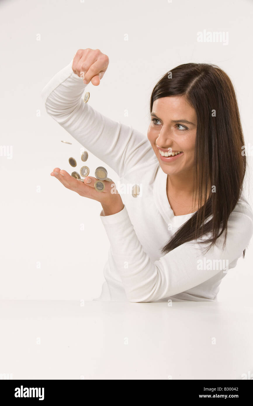 Woman Dropping Coins Stock Photo - Alamy