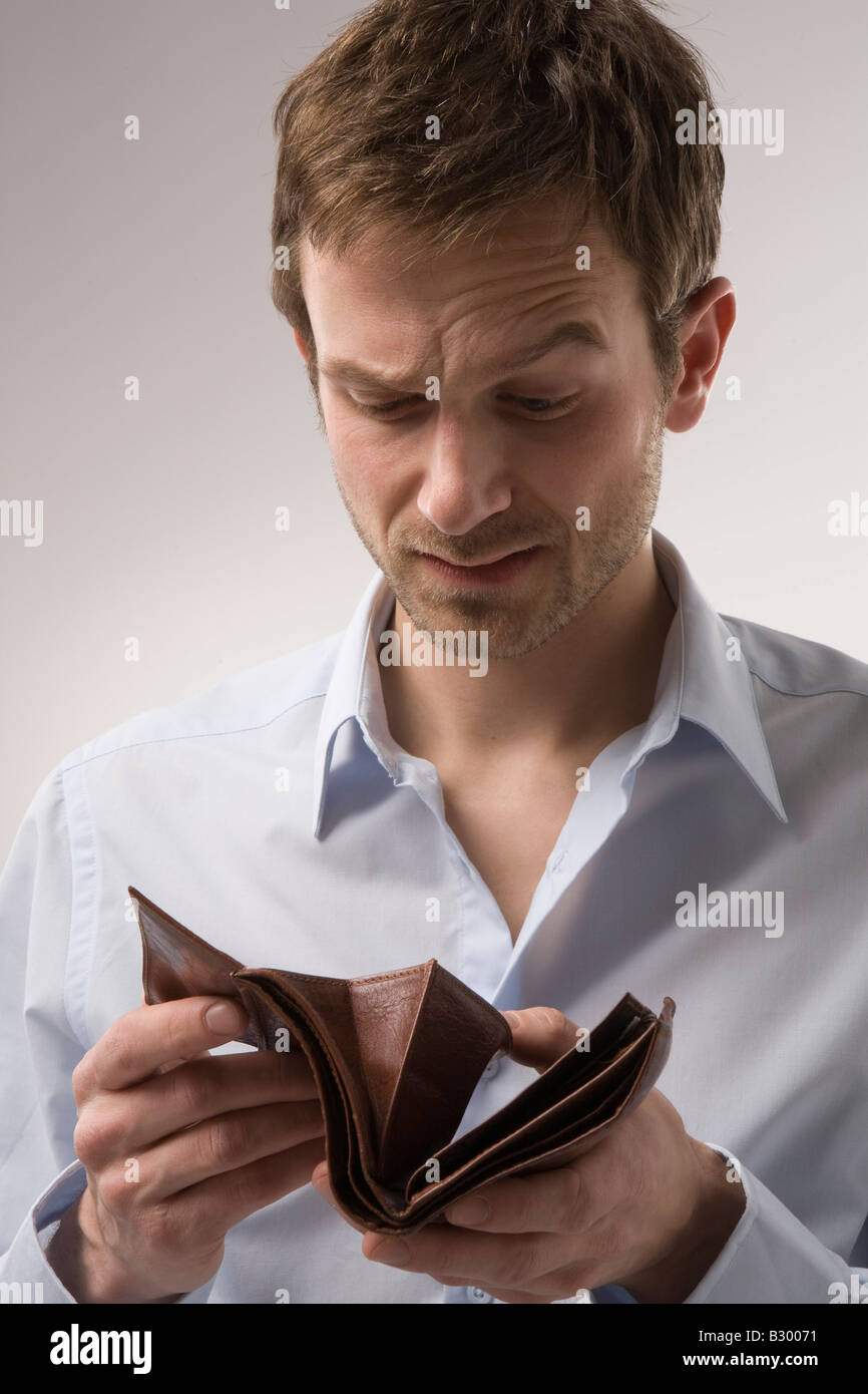 Man Looking in Empty Wallet Stock Photo - Alamy