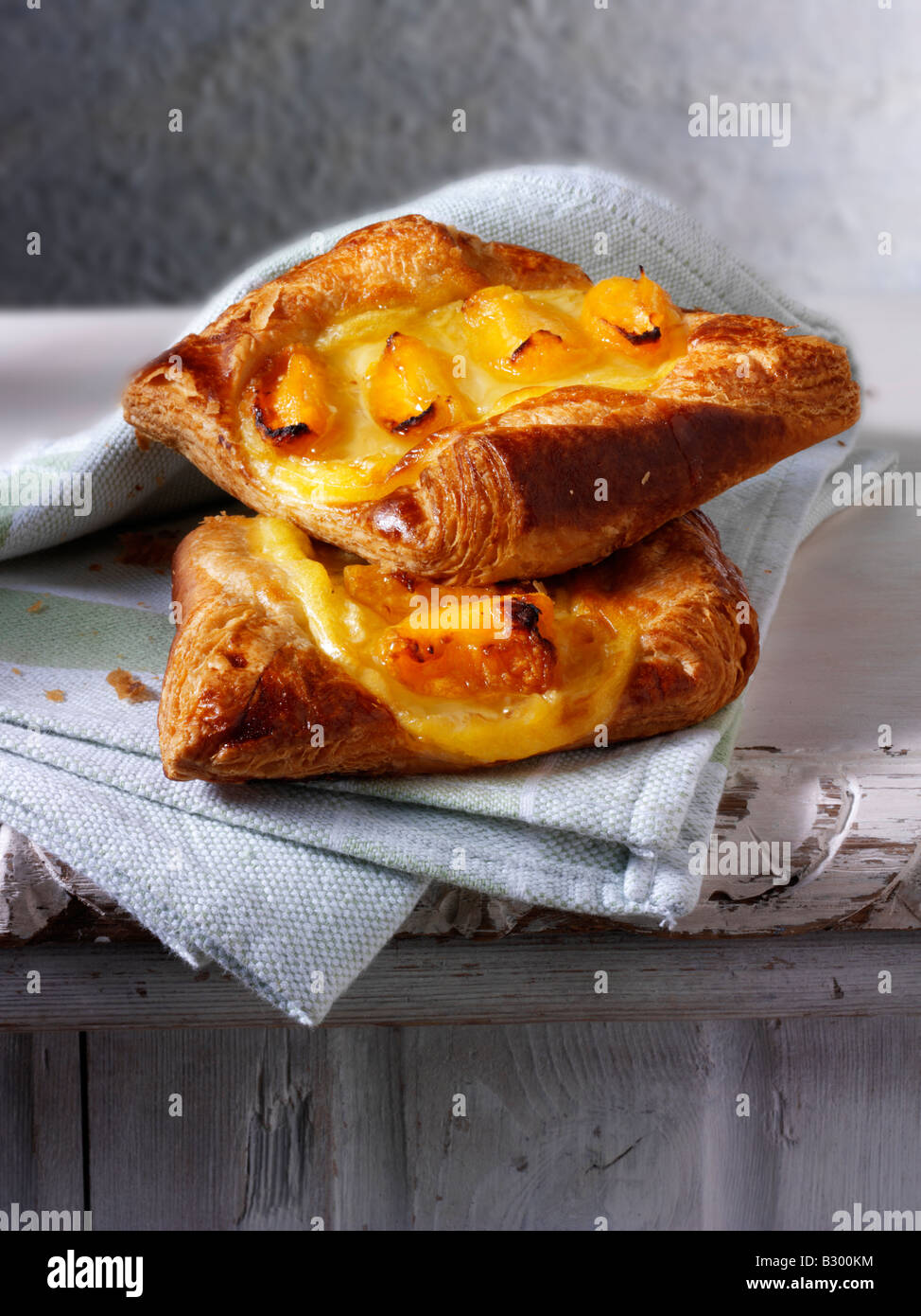 Glazed apricot pastry slice in a rustic setting on a wood table Stock ...