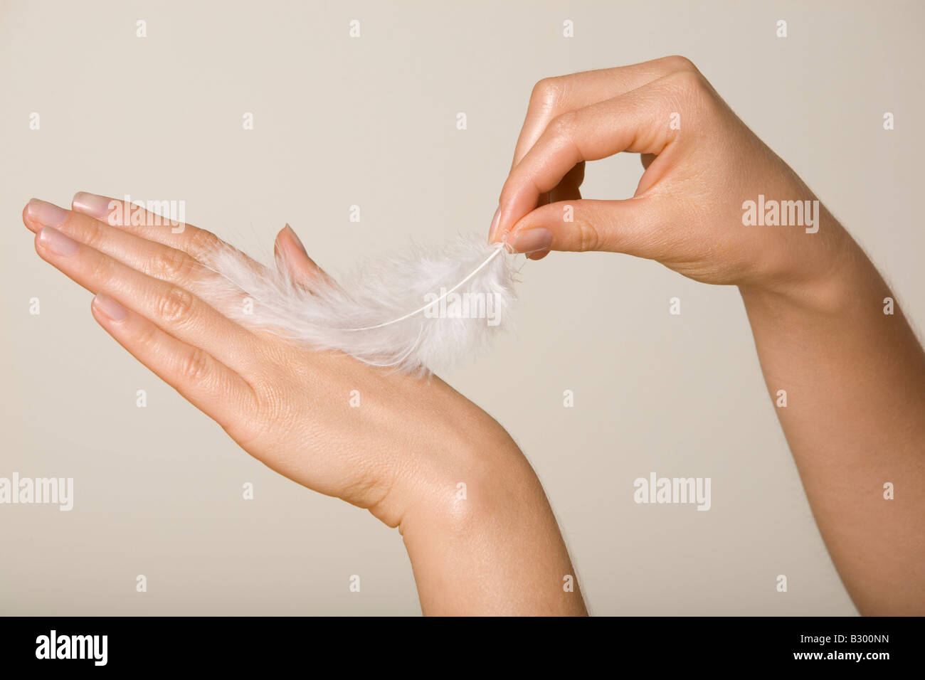 Woman Tickling Herself with Feather Stock Photo - Alamy