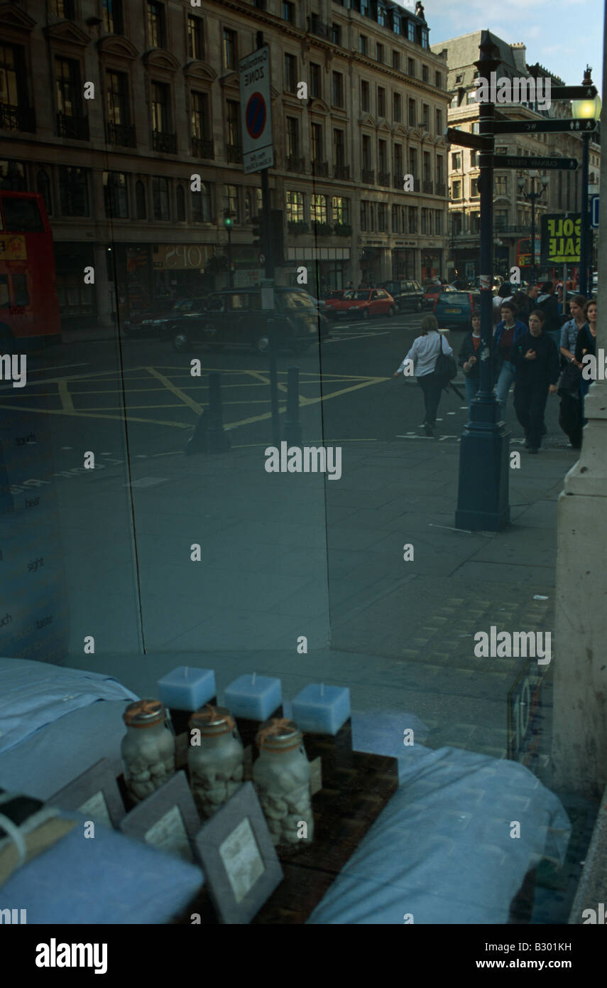 Street scene reflected on a shop window on Regent Street in London ...