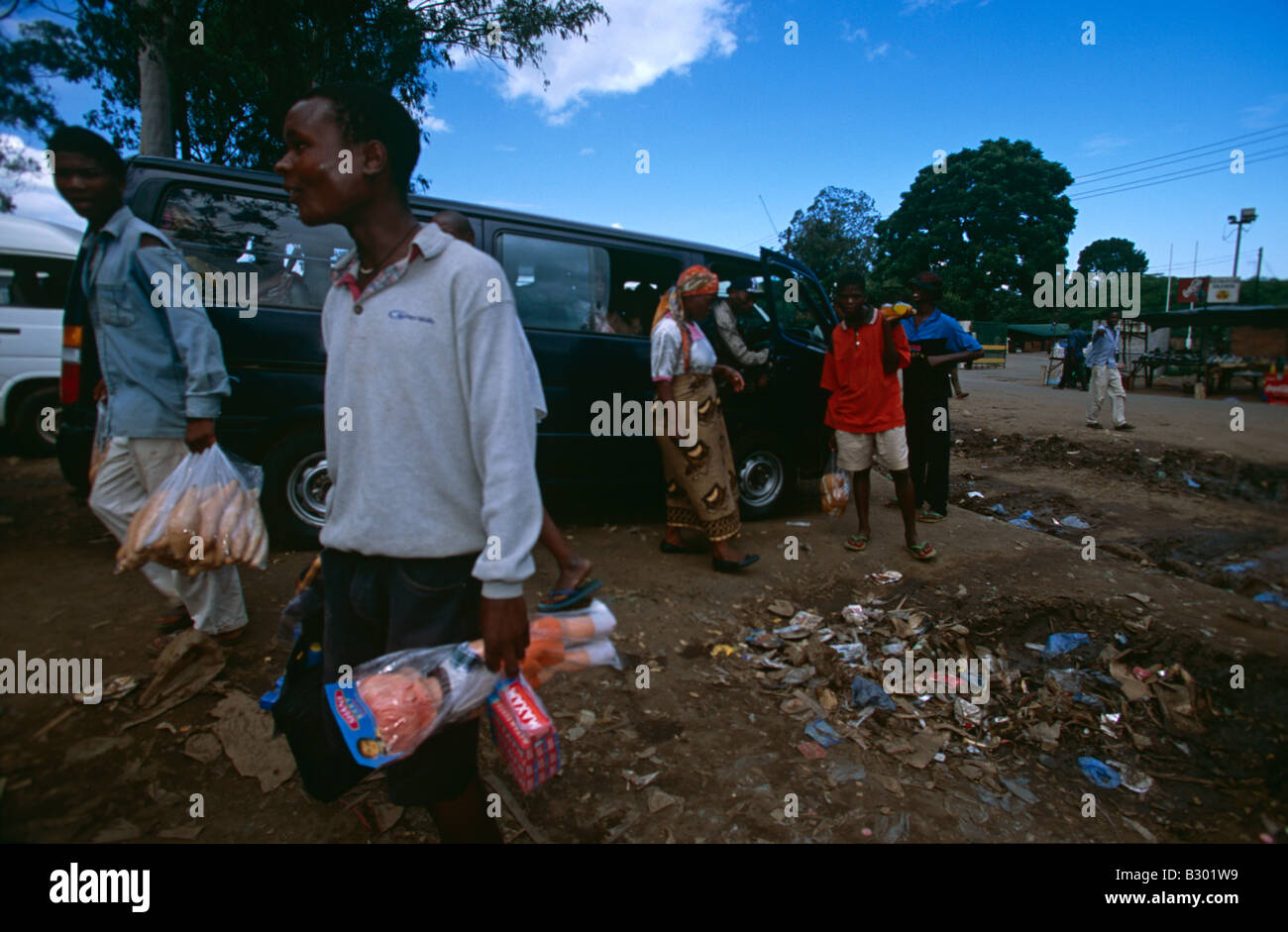 Men returning home with their shopping in Malawi Stock Photo - Alamy