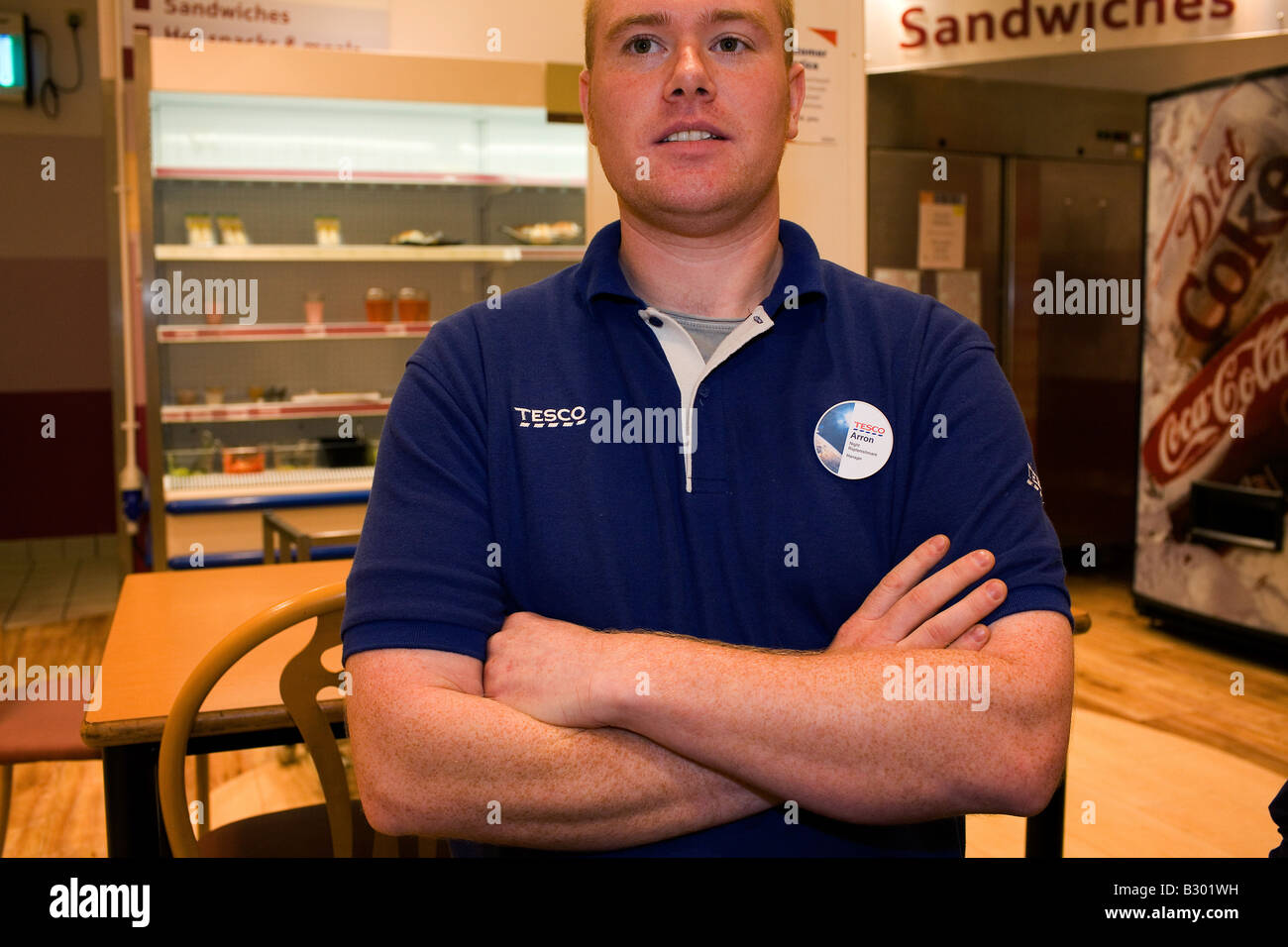 A young night shift male worker in the canteen at Tesco supermarket ...
