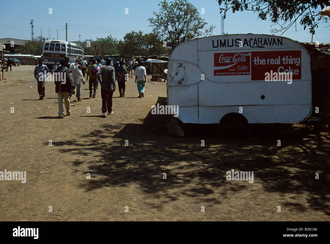 Locals walk past advertising signs in Malawi Stock Photo - Alamy