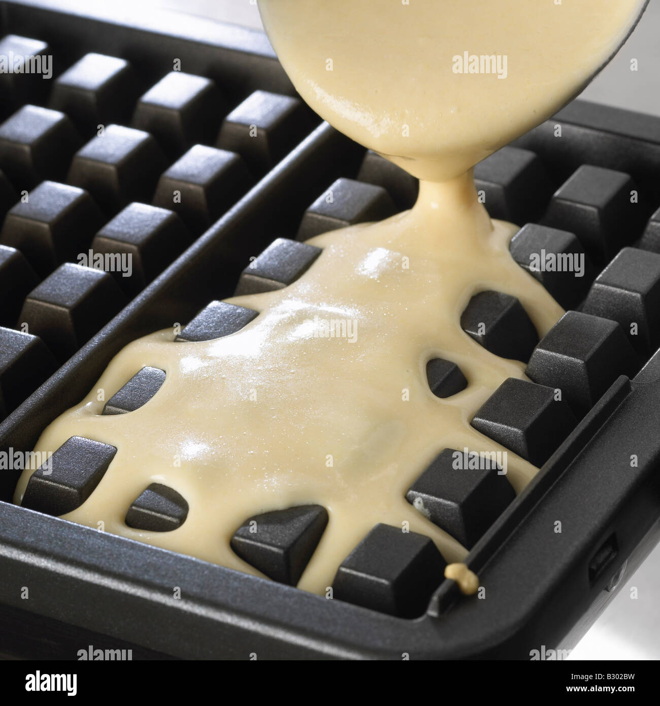 Pouring Batter in Waffle Iron Stock Photo - Alamy