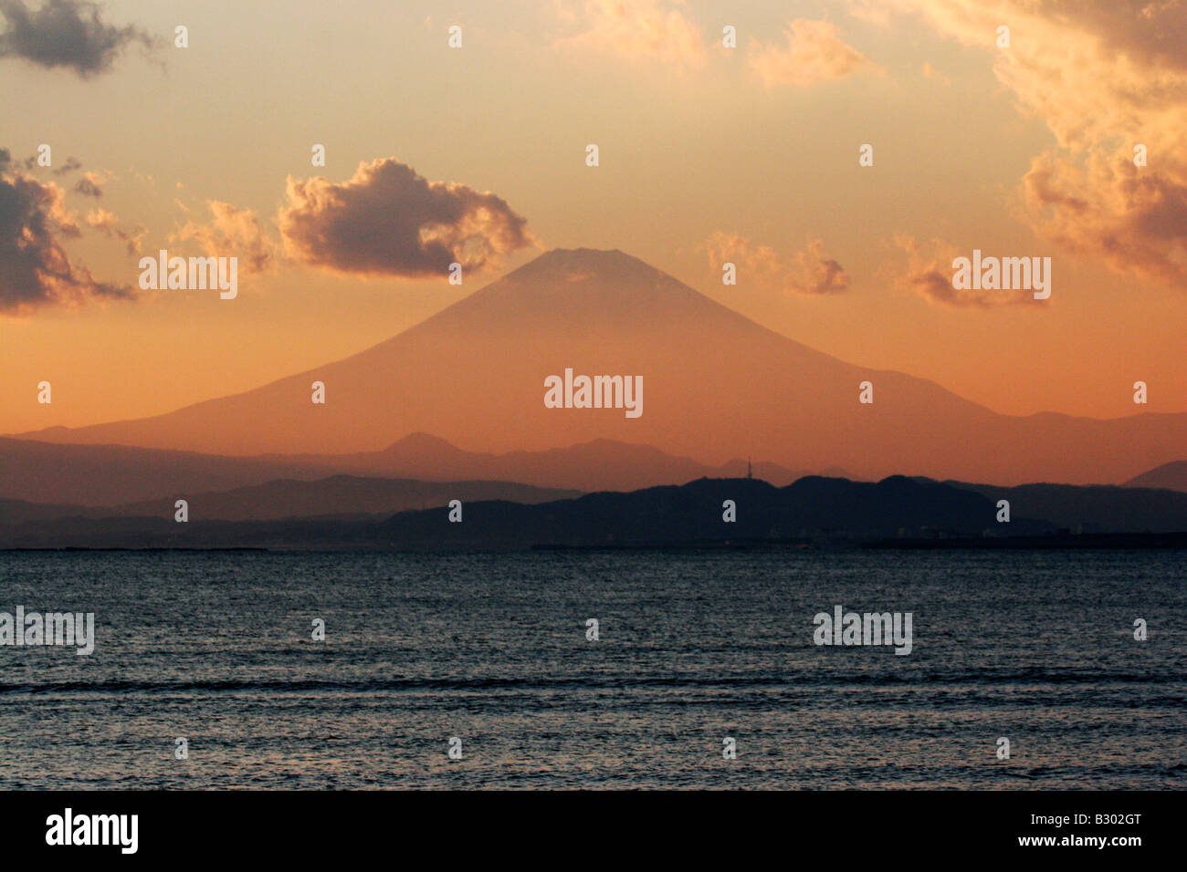 Mount Fuji stands illuminated by a warm late afternoon sun Stock Photo ...