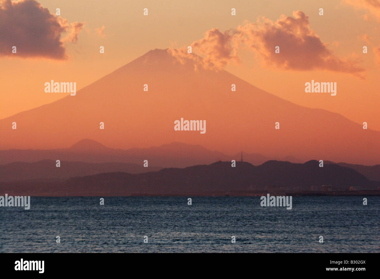 Mount Fuji stands illuminated by a warm late afternoon sun Stock Photo ...
