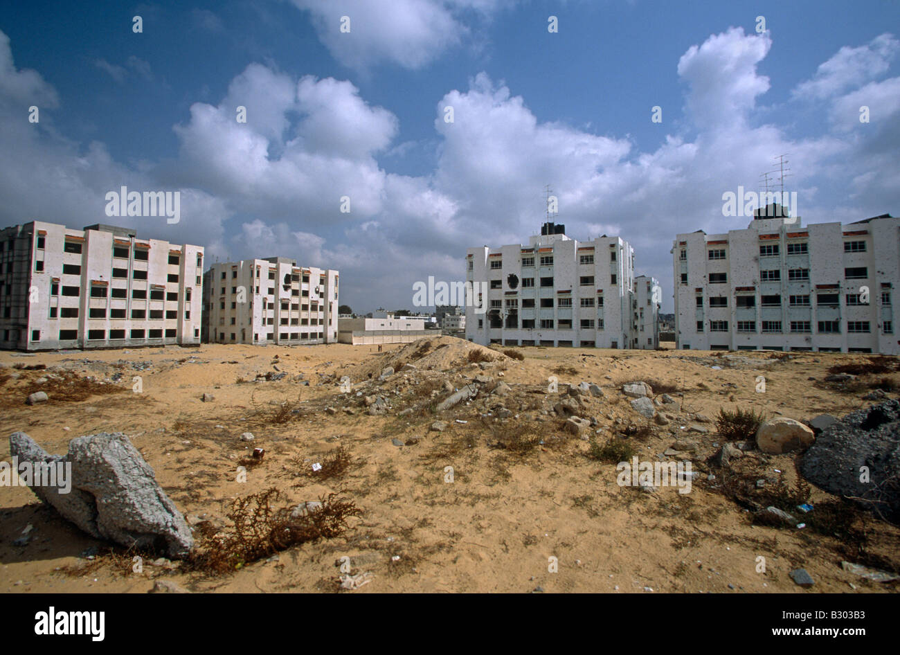 Debris on wasteland and whitewash apartment blocks, Gaza, Palestine ...
