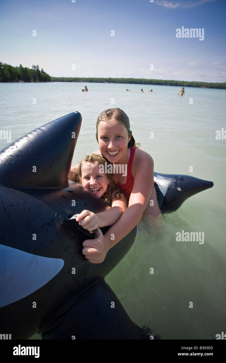 Girls in Water with Inflatable Whale Stock Photo - Alamy