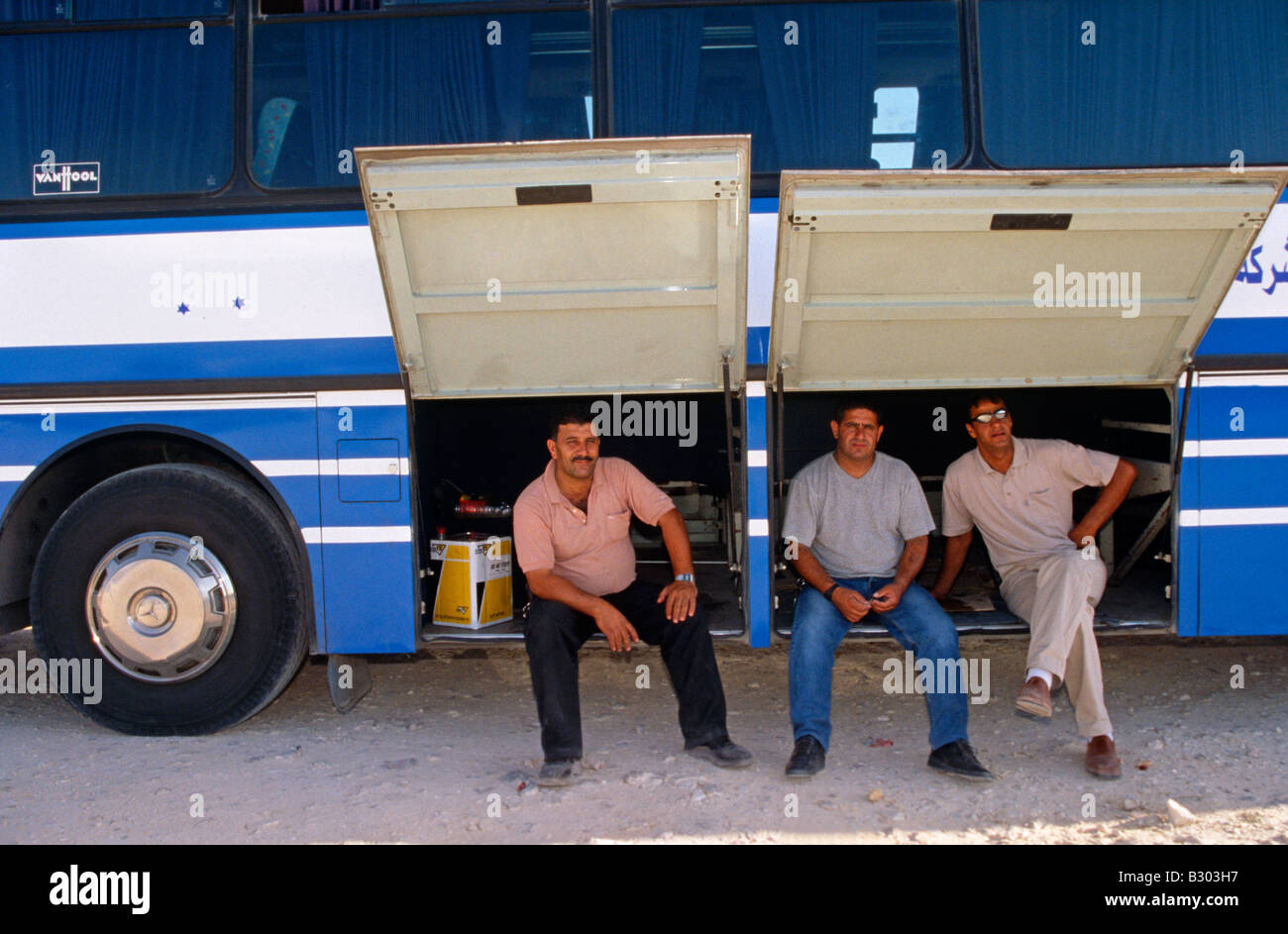 Men sitting on the side of a bus in Palestine Stock Photo - Alamy
