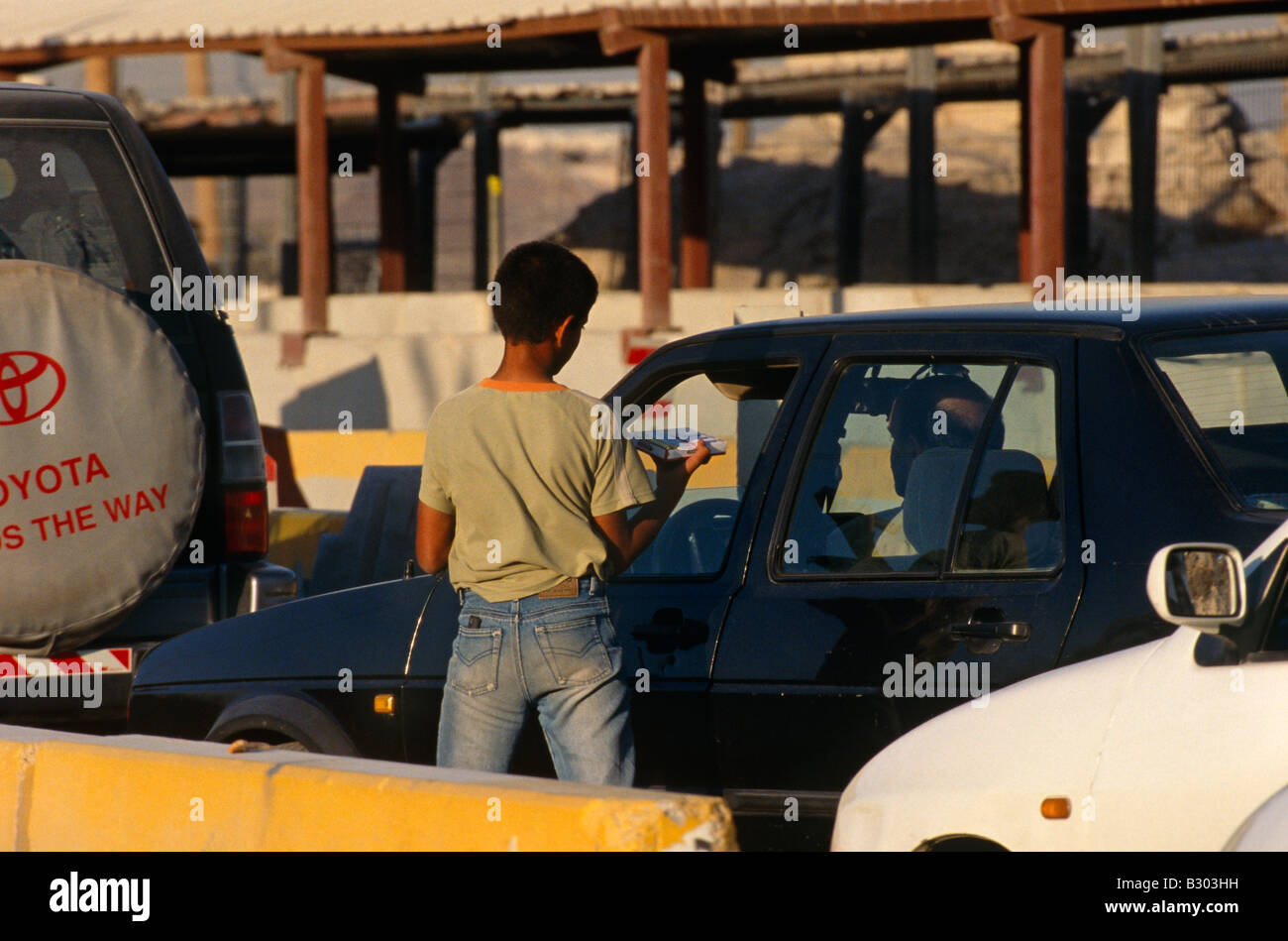Young street vendor selling to cars in traffic. Palestine Stock Photo ...