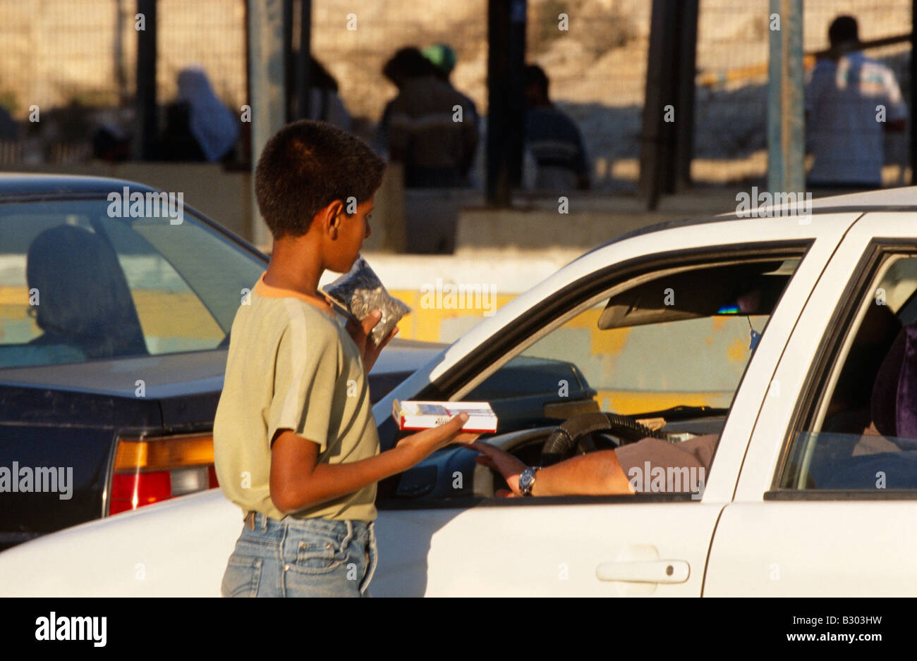 Young street vendor selling to cars in traffic. Palestine Stock Photo ...