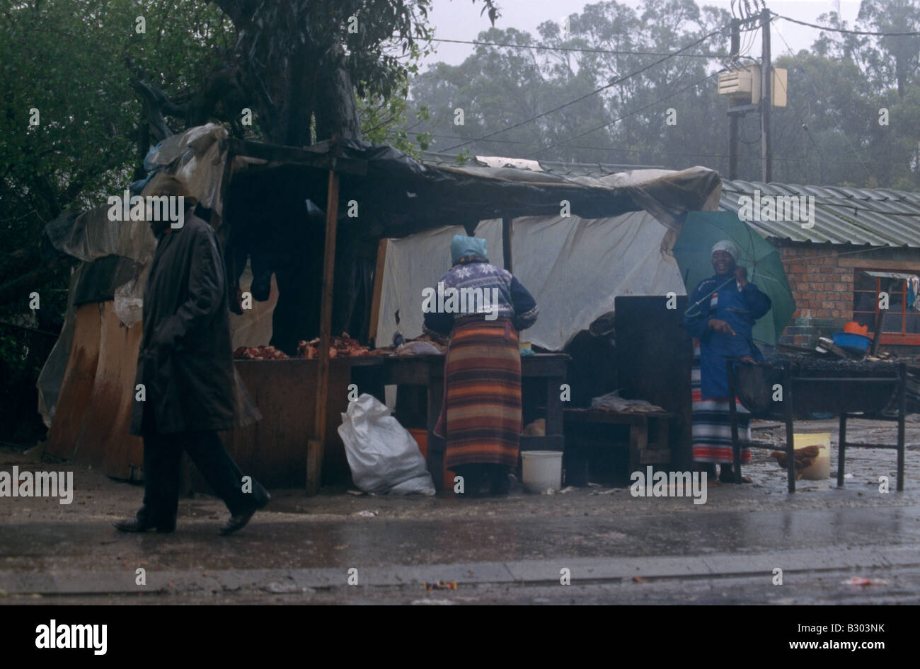 Street scene and street market stalls during rainstorm, Gugulethu ...