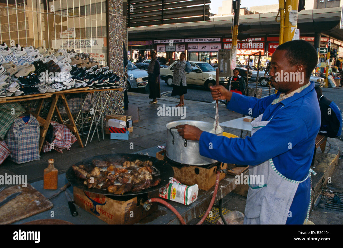 Stall holder cooking on street market stall, Johannesburg, South Africa ...